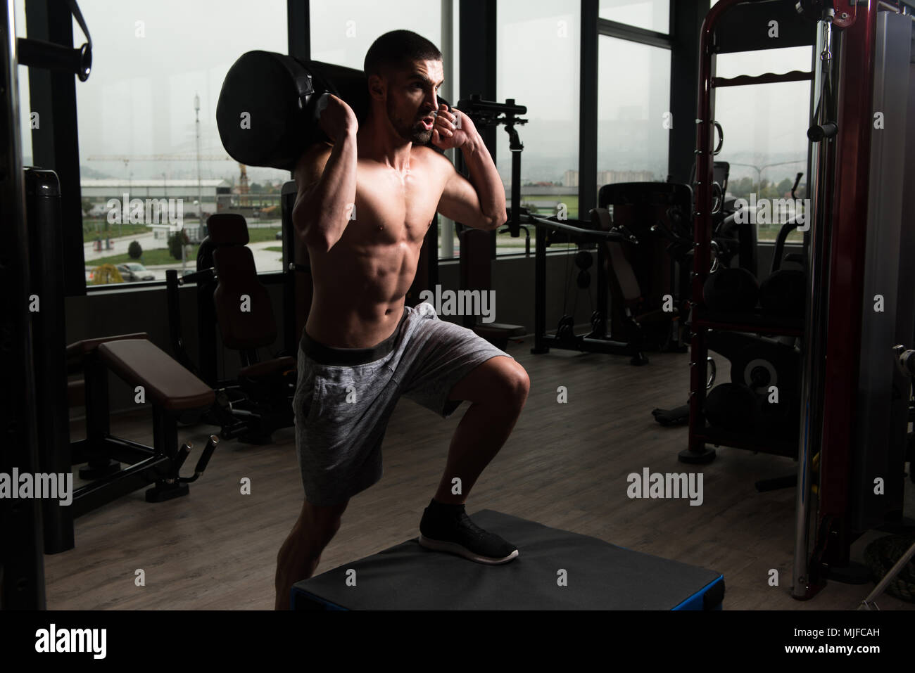 Fit Young Man Doing Box Jumping At A Style Gym - Male Athlete Is ...