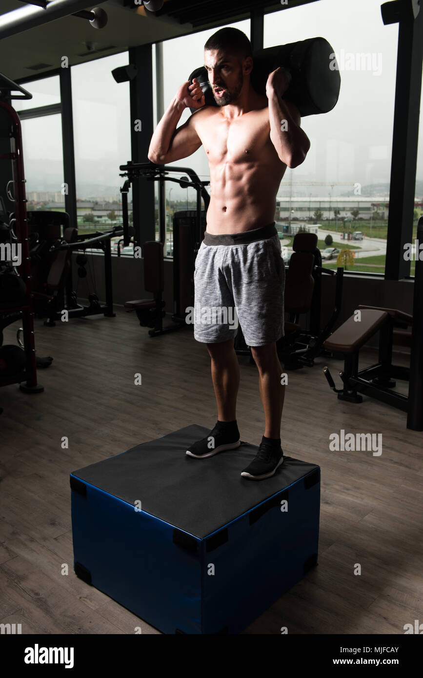 Fit Young Man Doing Box Jumping At A Style Gym - Male Athlete Is ...