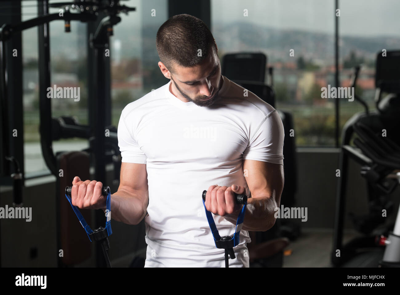 Muscular Fitness Bodybuilder Doing Heavy Weight Exercise For Biceps On ...