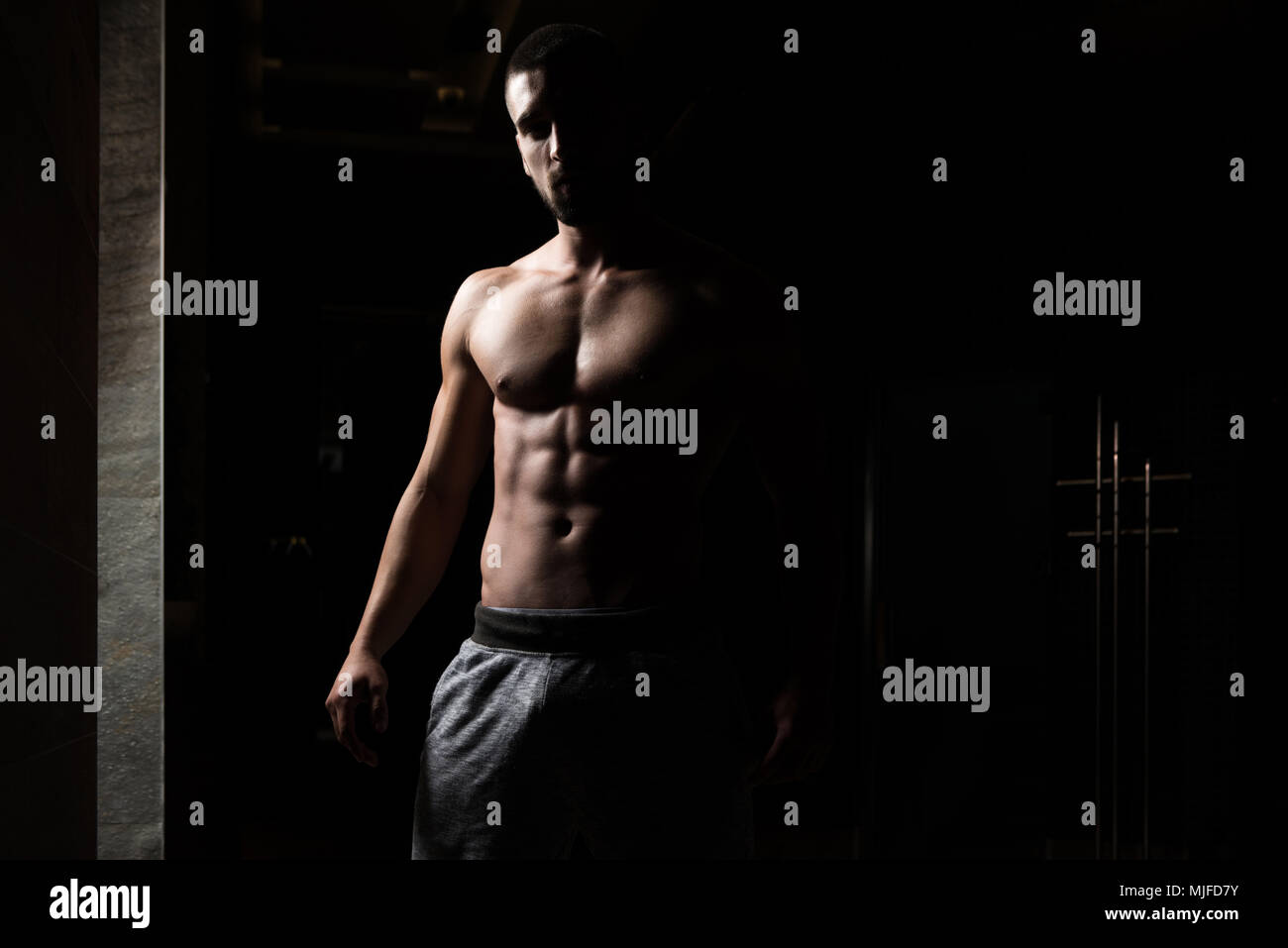 Portrait Of A Physically Fit Man Showing His Well Trained Body In Dark ...