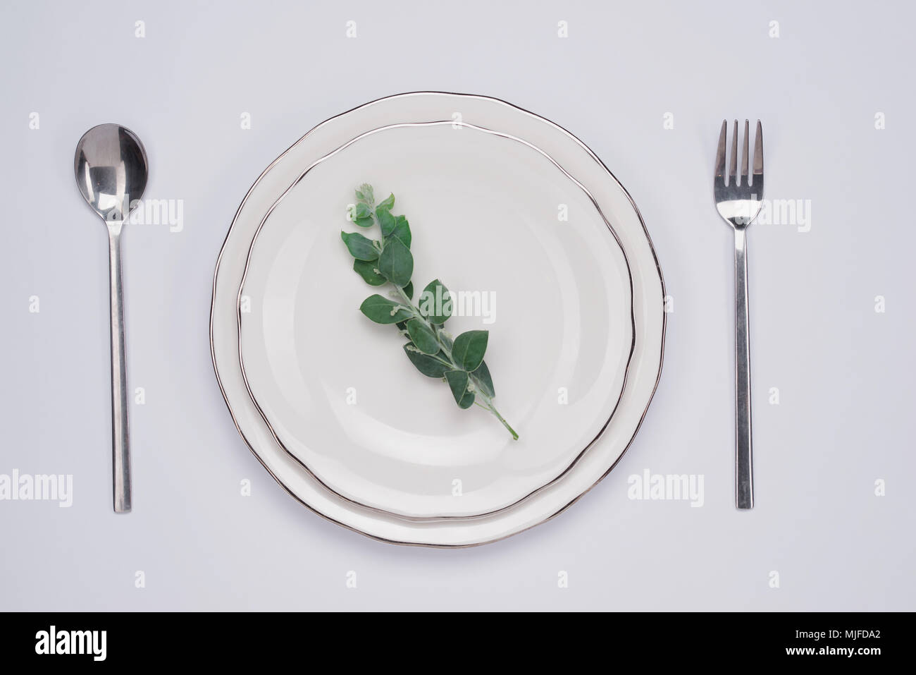 Dinner plate setting top view. Empty plate and silverware set on wooden ...