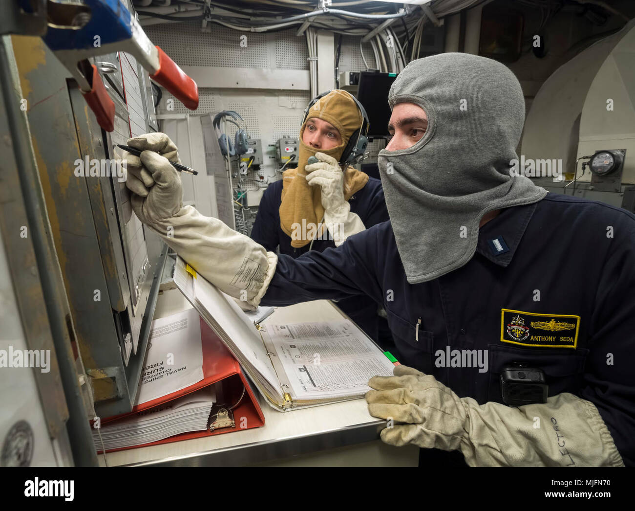 PHILIPPINE SEA (March 20, 2018) Ens. Anthony Seda, right, and Logistics ...