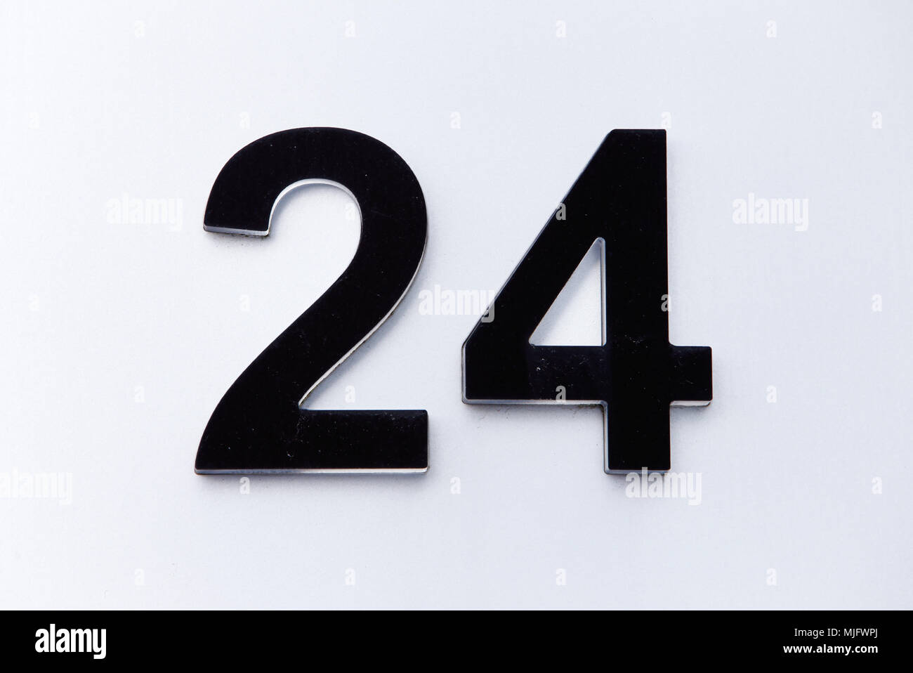 House number 24 in black against a light wall Stock Photo - Alamy