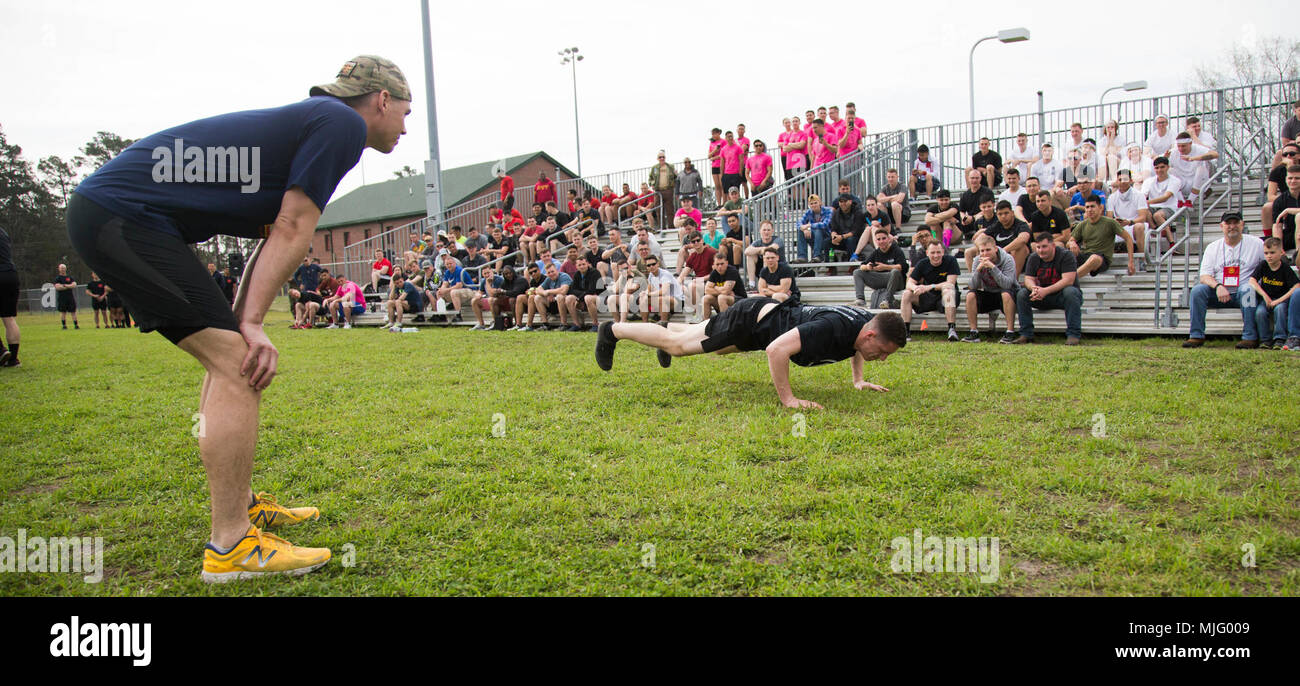 U.S. Marine Corps Capt. Vincent Curley flips a tire during Marine Light ...