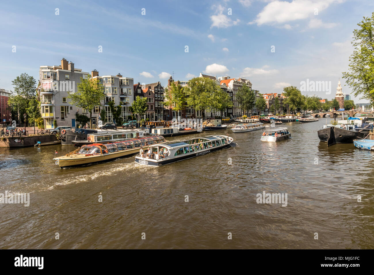 Boats on the 17th Century canal ring taking goods and tourist site ...