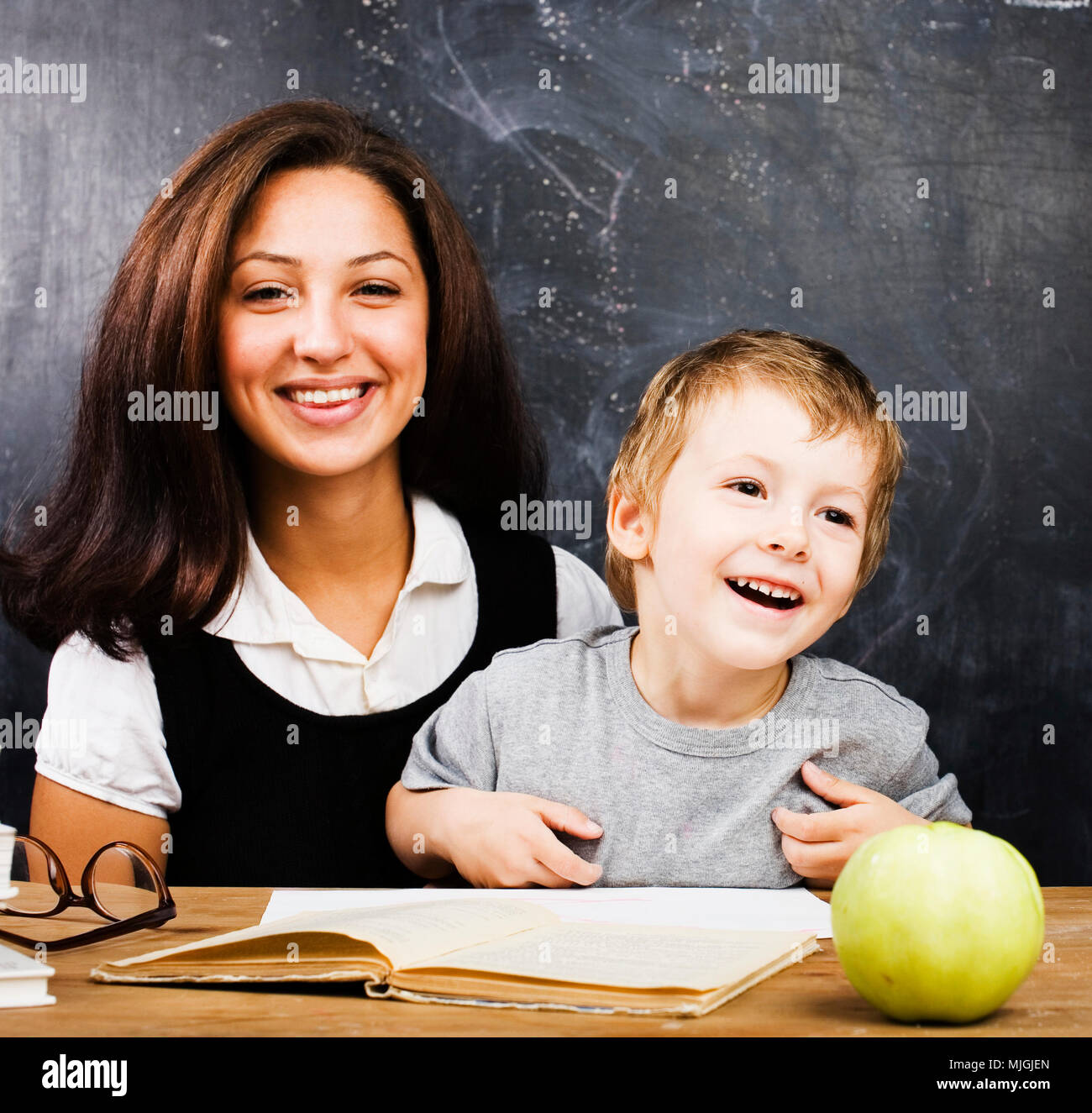 little cute boy with teacher in classroom smiling, lifestyle people ...