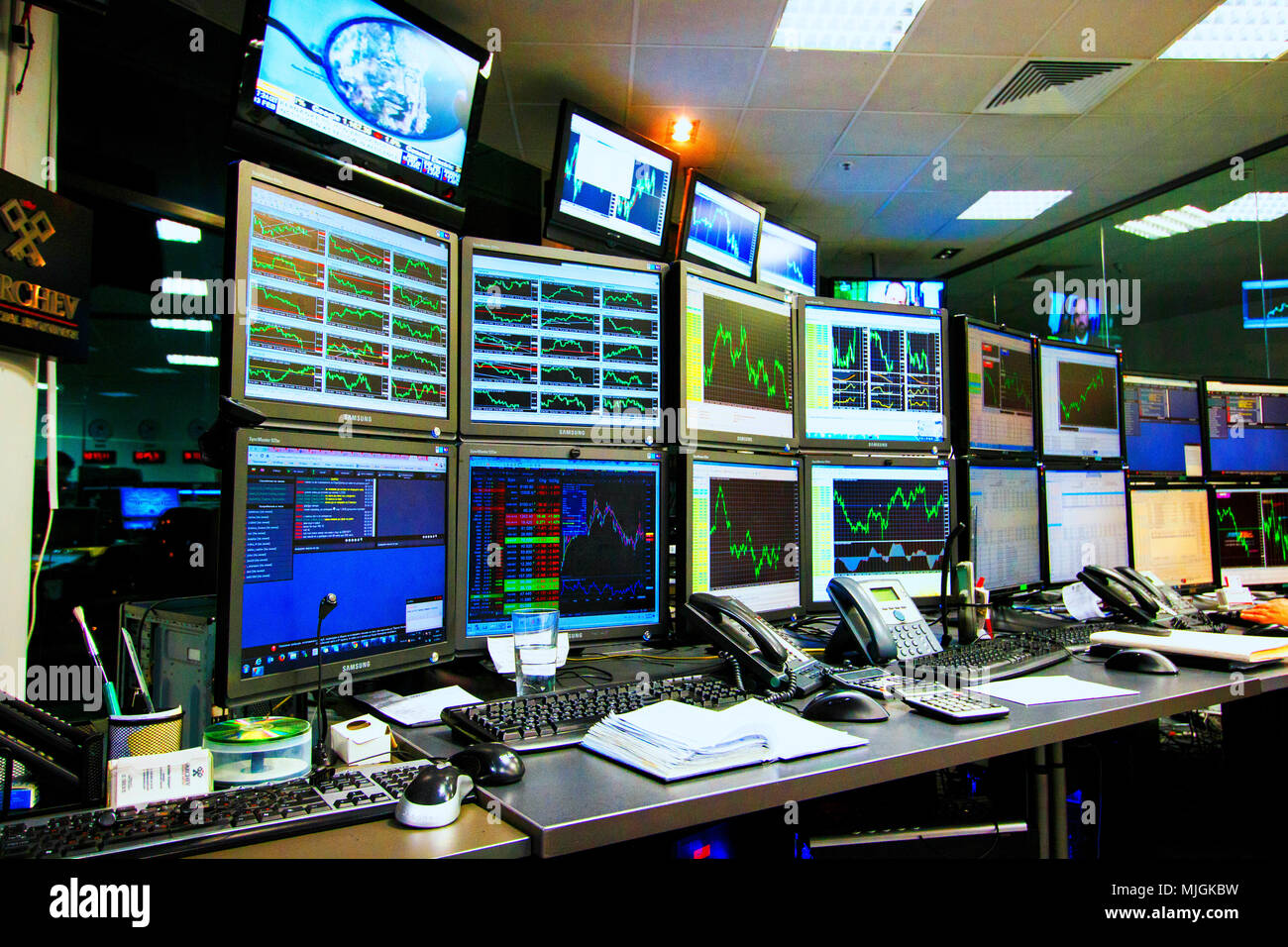 Computer screens on desk showing charts and data analyses Stock Photo ...