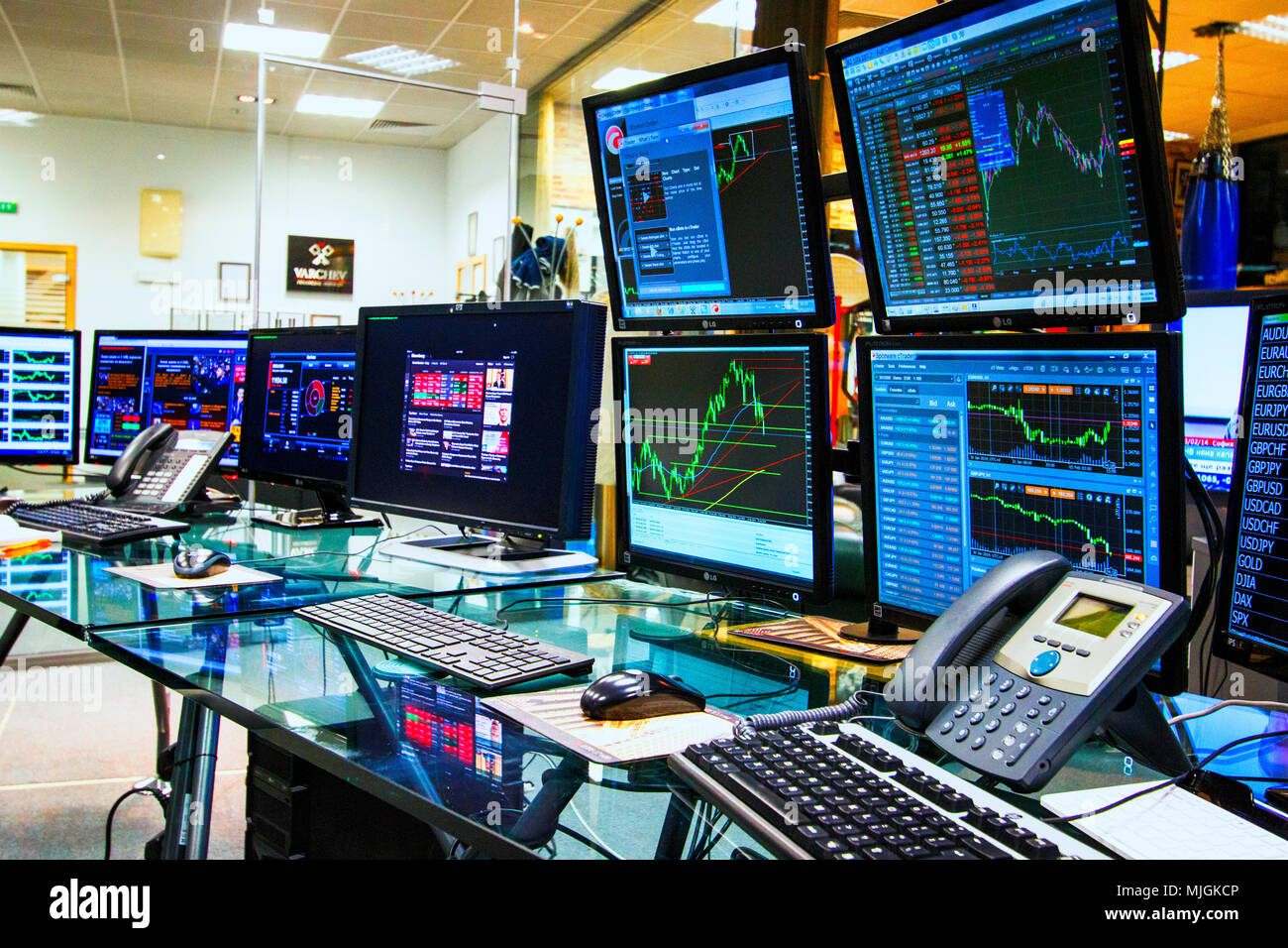 Computer screens on desk showing charts and data analyses Stock Photo ...