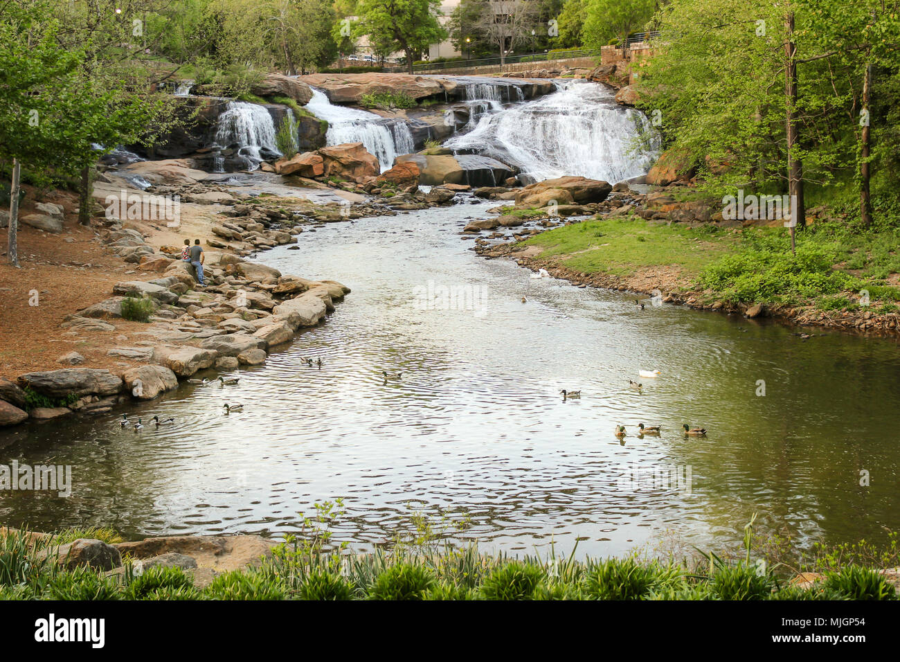 Golden hour view of waterfall and river in Greenville Falls park with ...