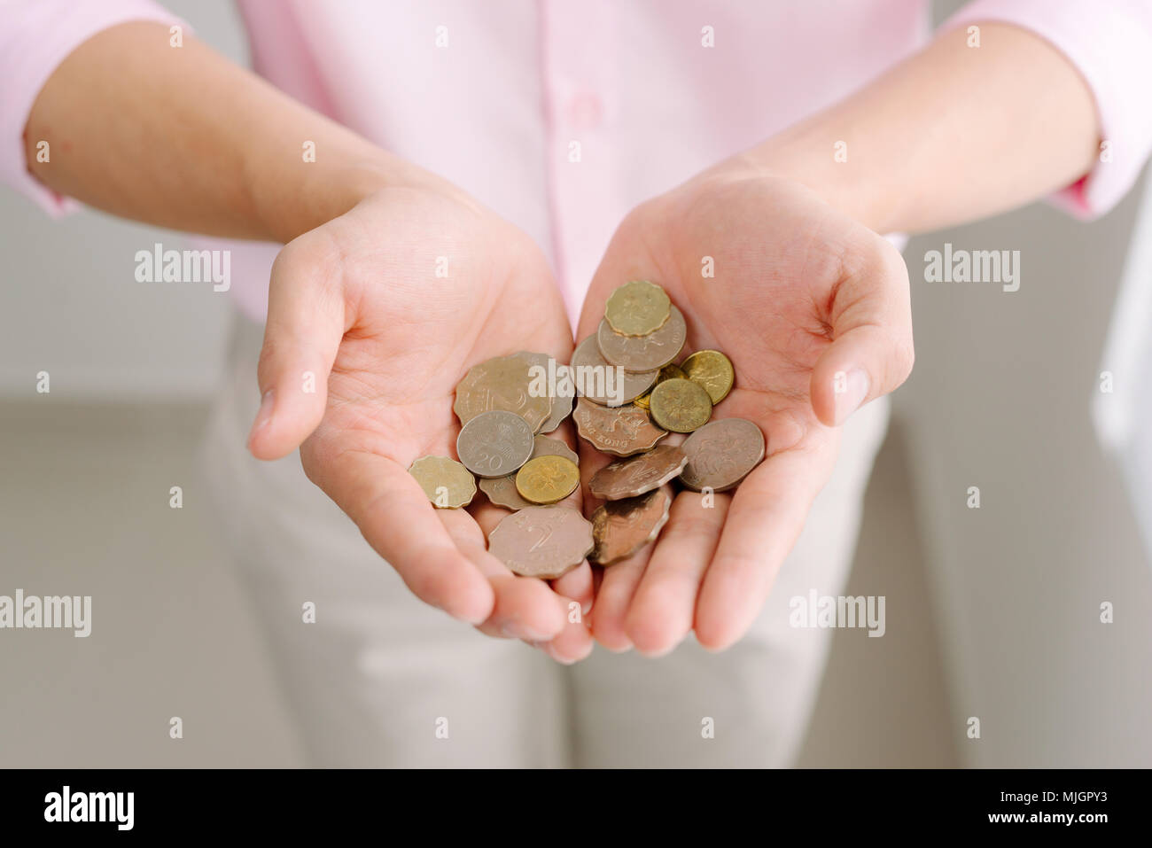 Coins in male hands. Saving money concept Stock Photo - Alamy