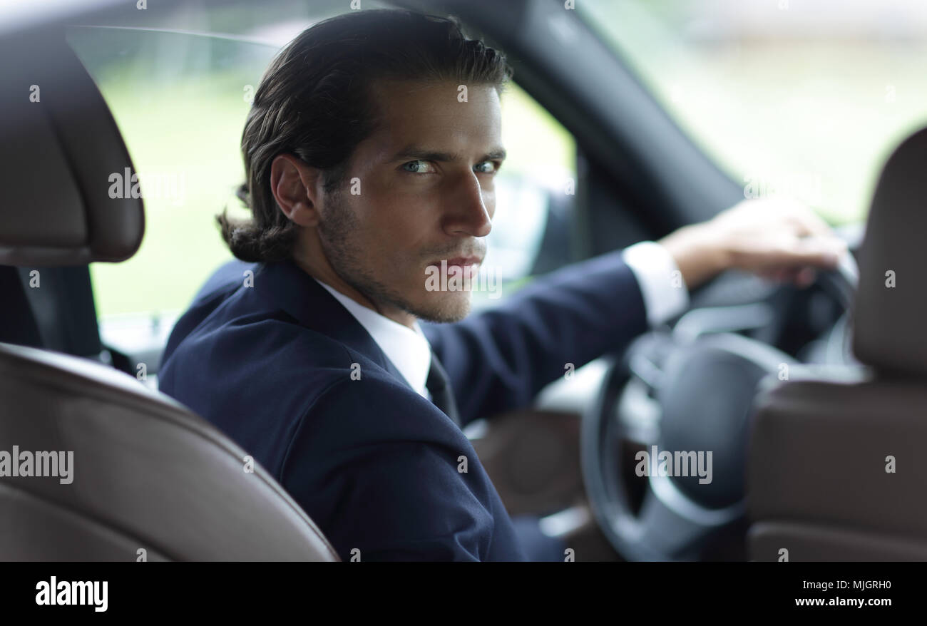 man sitting behind the wheel of a car Stock Photo - Alamy