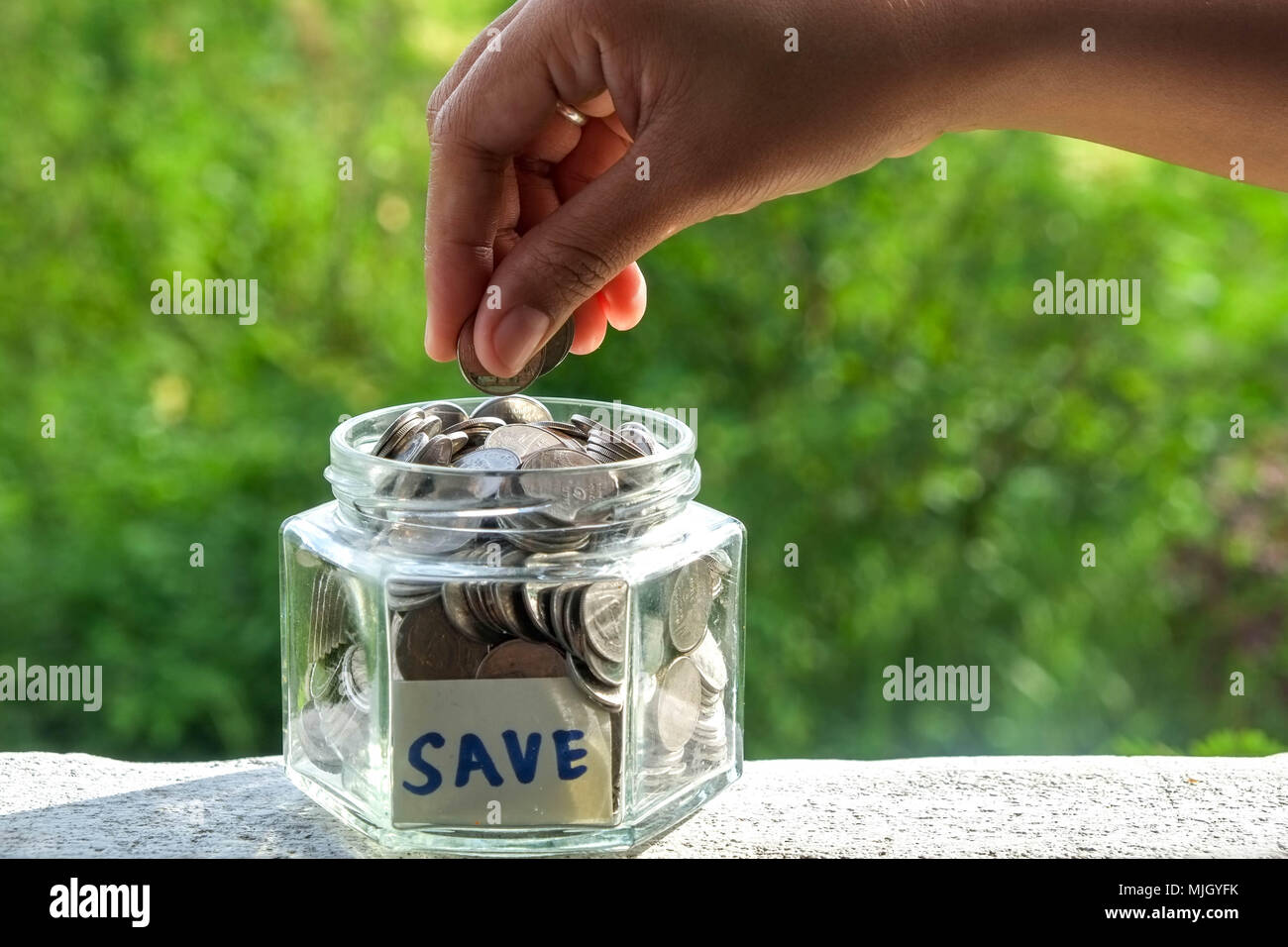 hand putting money coins Stock Photo - Alamy
