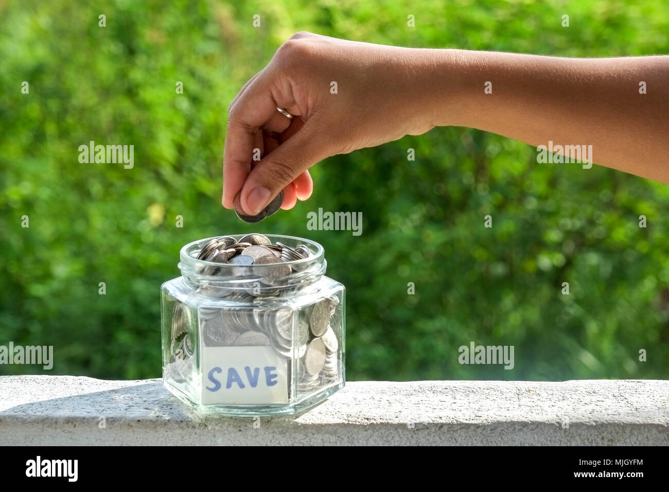 hand putting money coins Stock Photo - Alamy