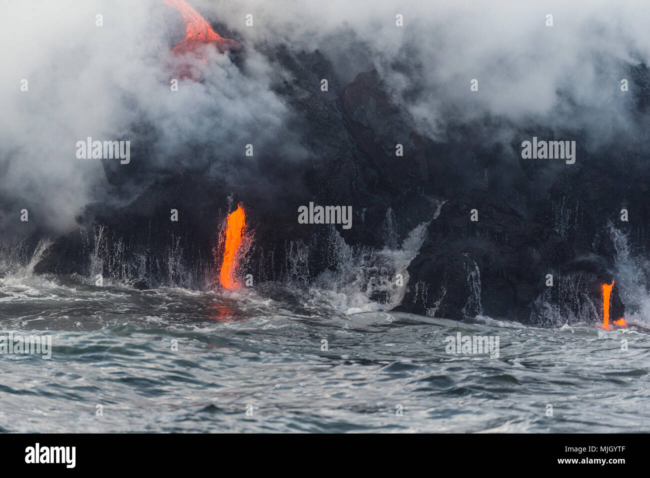 Streams of lava pour into the Pacific Ocean from Kilauea Volcano ...