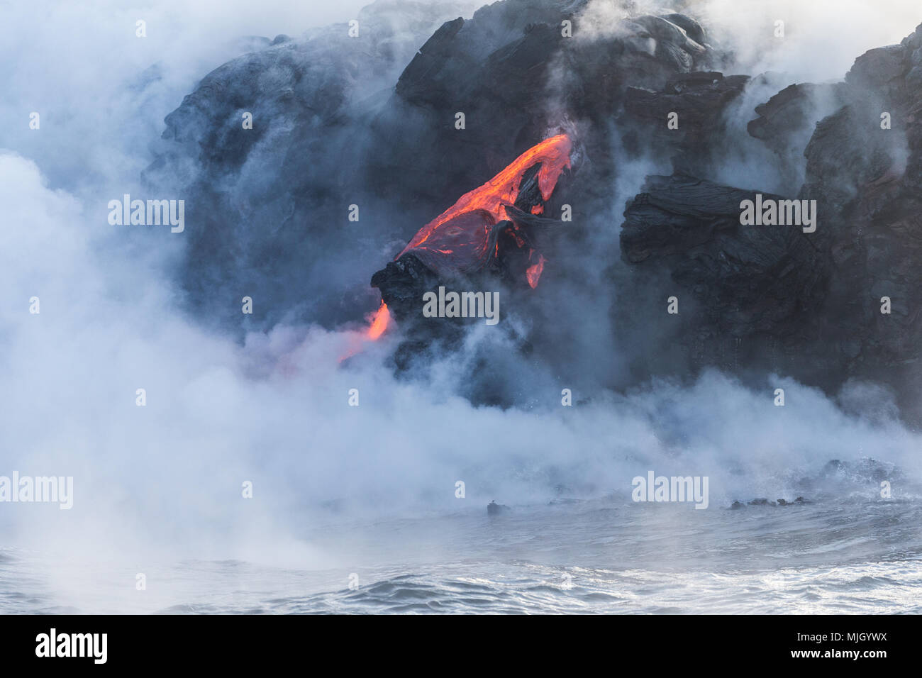 Streams of lava pour into the Pacific Ocean from Kilauea Volcano ...