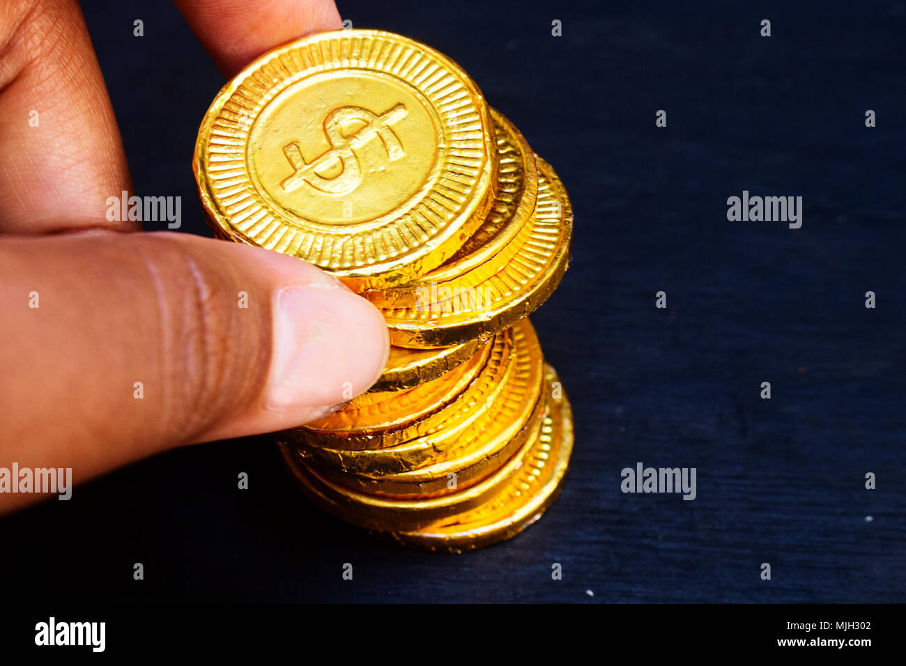 Black Skin Finger Hold Gold Coin With Dollar Currency Write on It. Gold ...