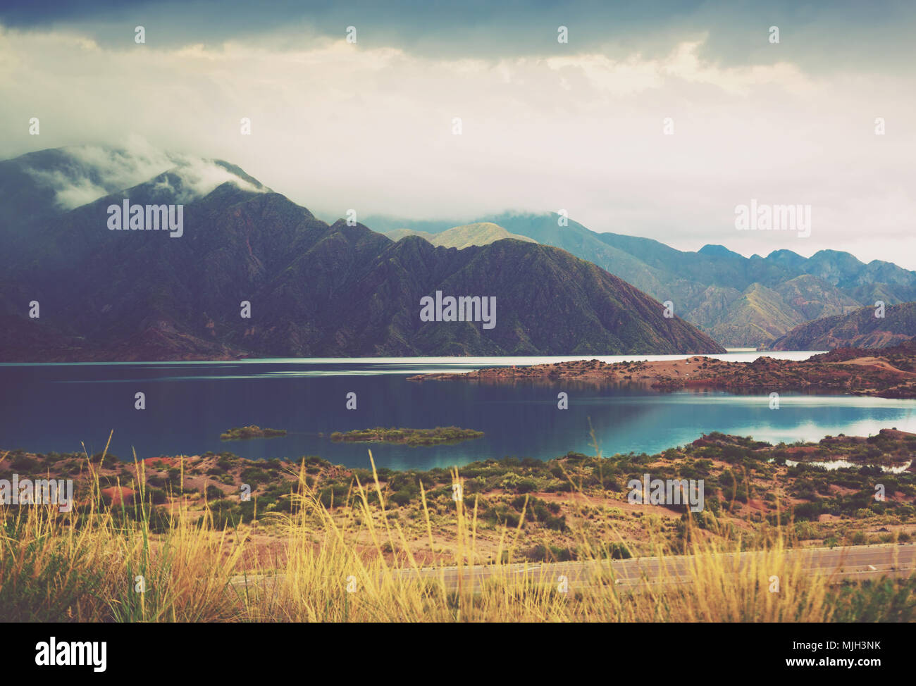 View of lake near Potrerillos and Andes mountains in summer day ...