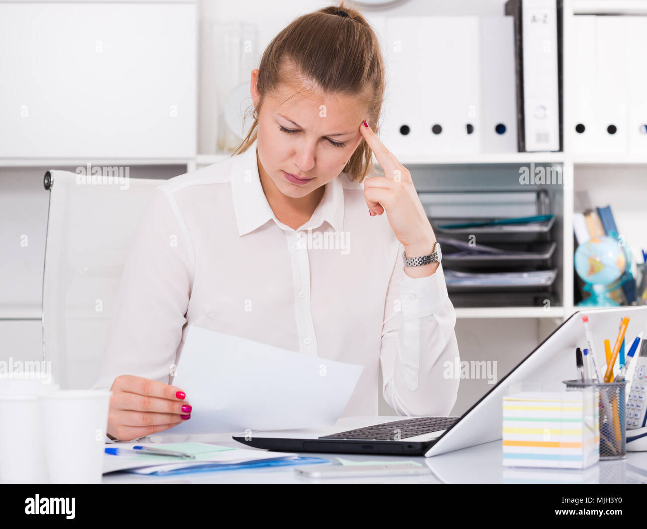 Female is having complicated issue with project in office Stock Photo ...