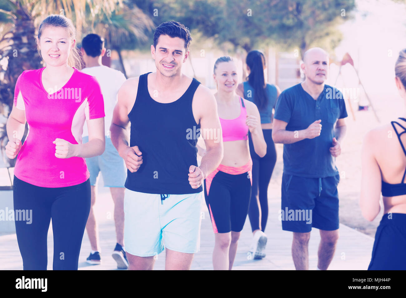 Active smiling people during running training in daytime Stock Photo ...