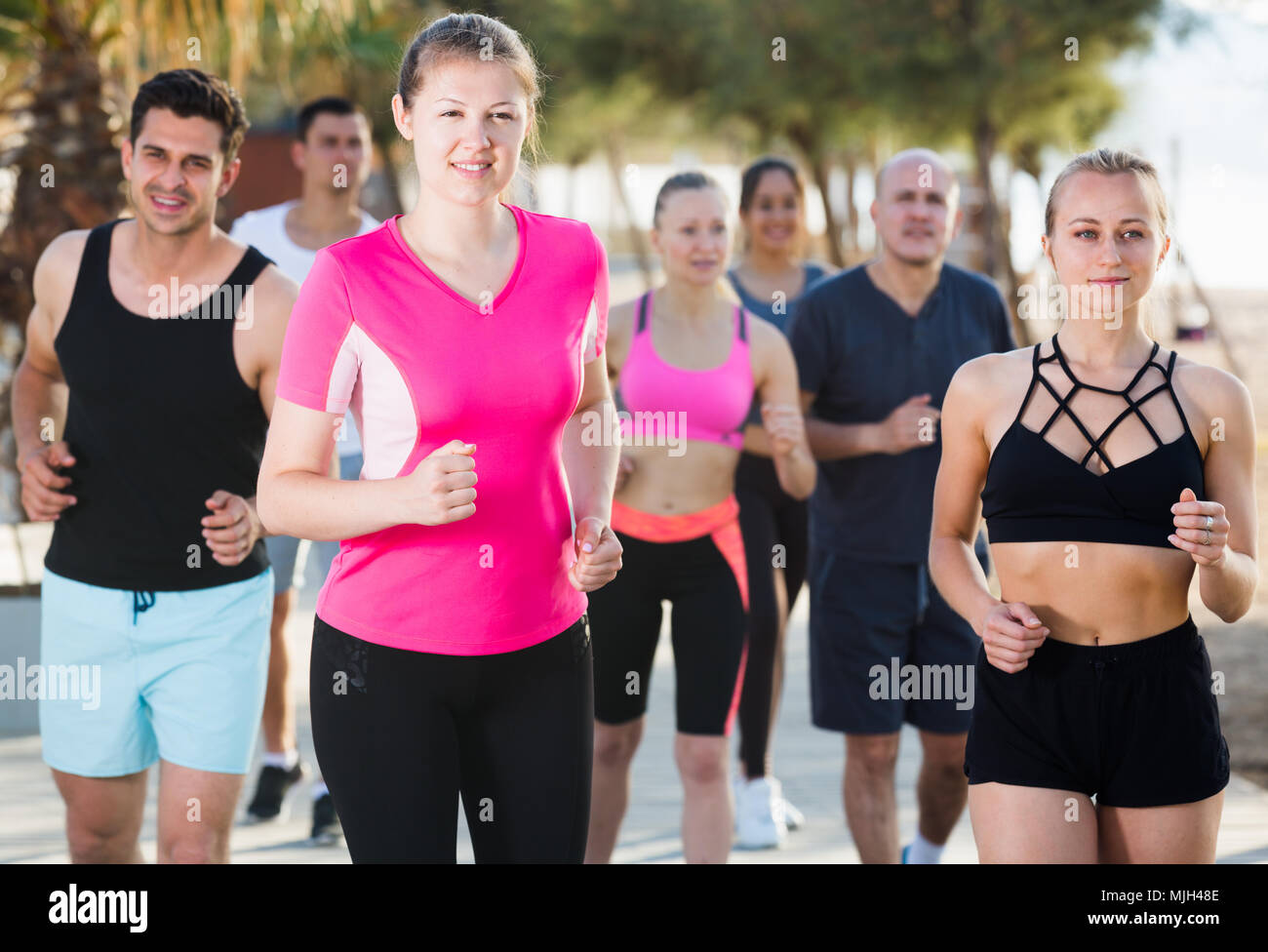 Active smiling people during running training in daytime Stock Photo ...