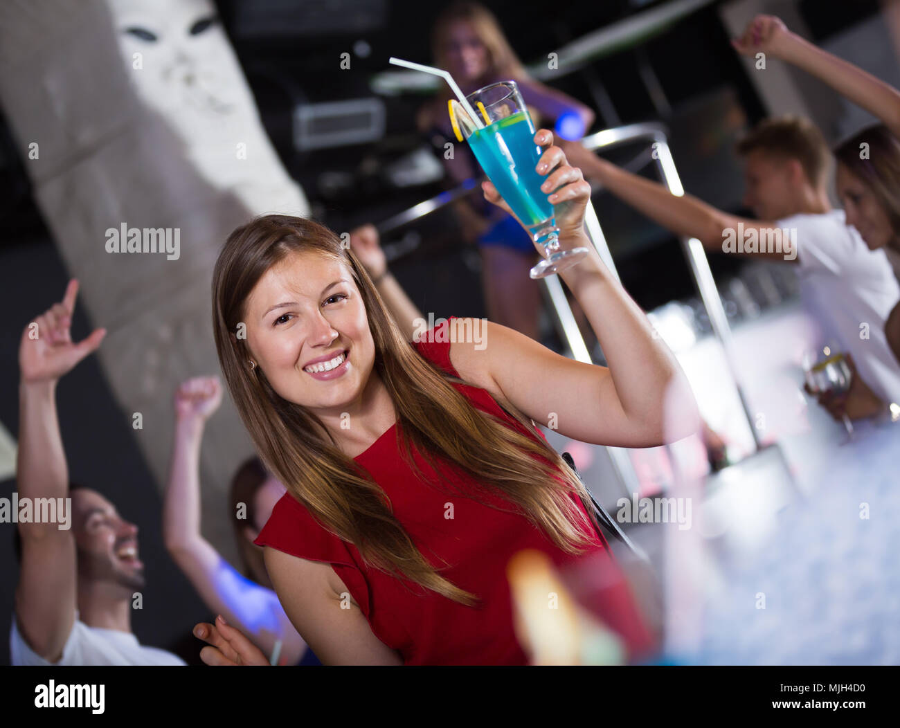 Positive woman dancing in the night club with drinks in the hand Stock ...