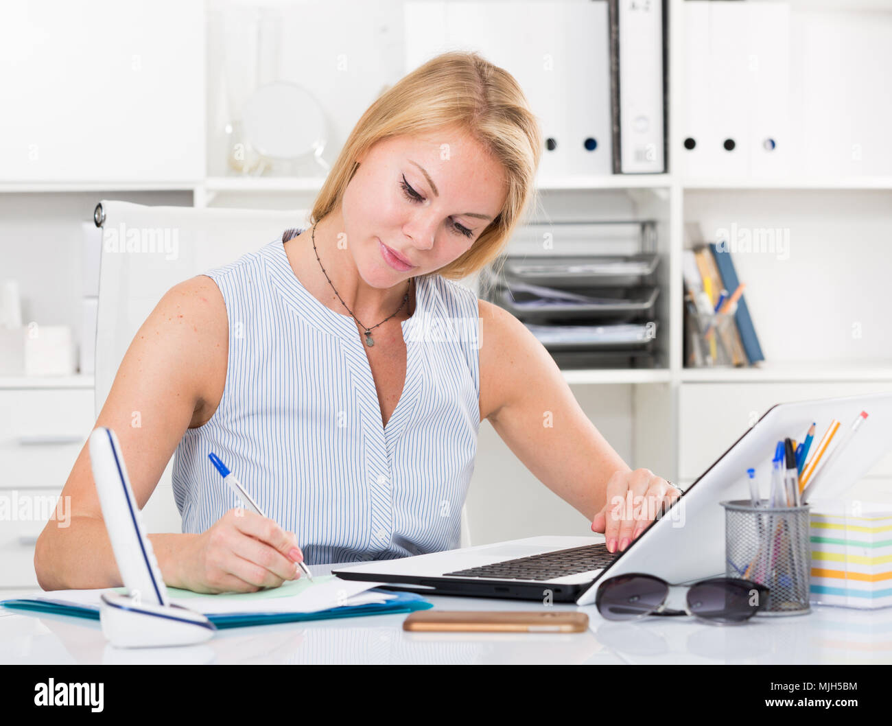 portrait of adult spanish girl business manager writing and working ...