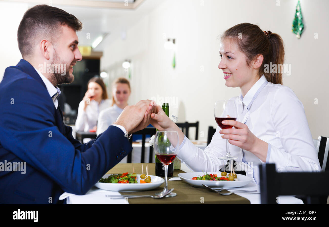 Elegant female and her boyfriend are celebrating date for dinner in ...