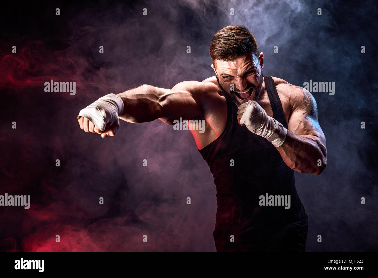 Sport concept. Sportsman muay thai boxer fighting on black background ...