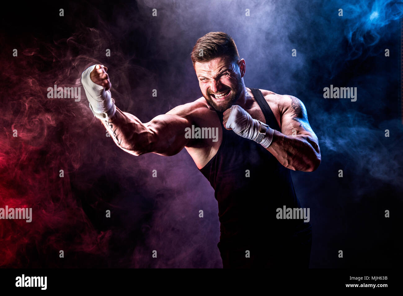 Sport concept. Sportsman muay thai boxer fighting on black background ...