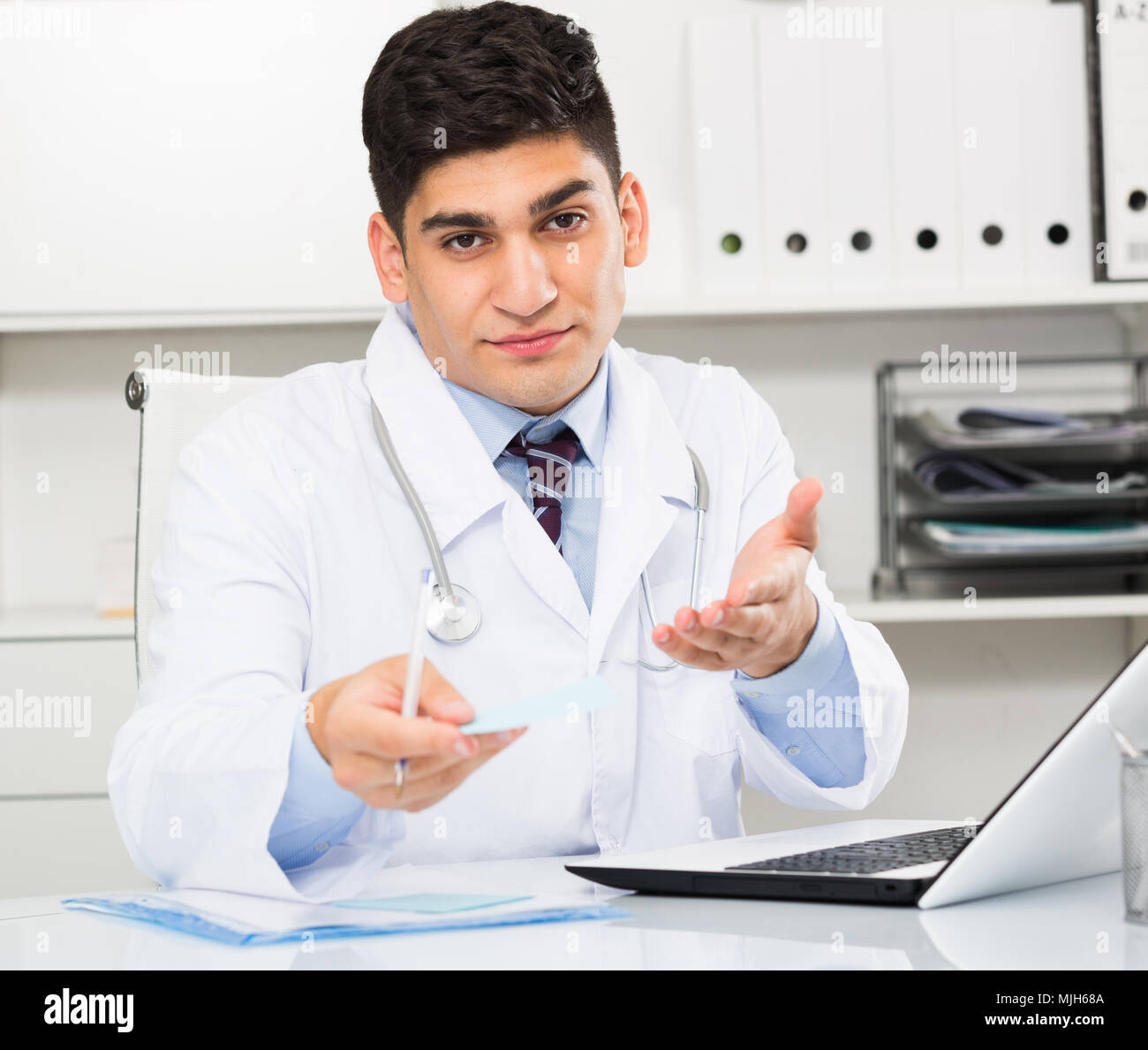 Adult doctor is giving the conclusion about health of client in clinic ...