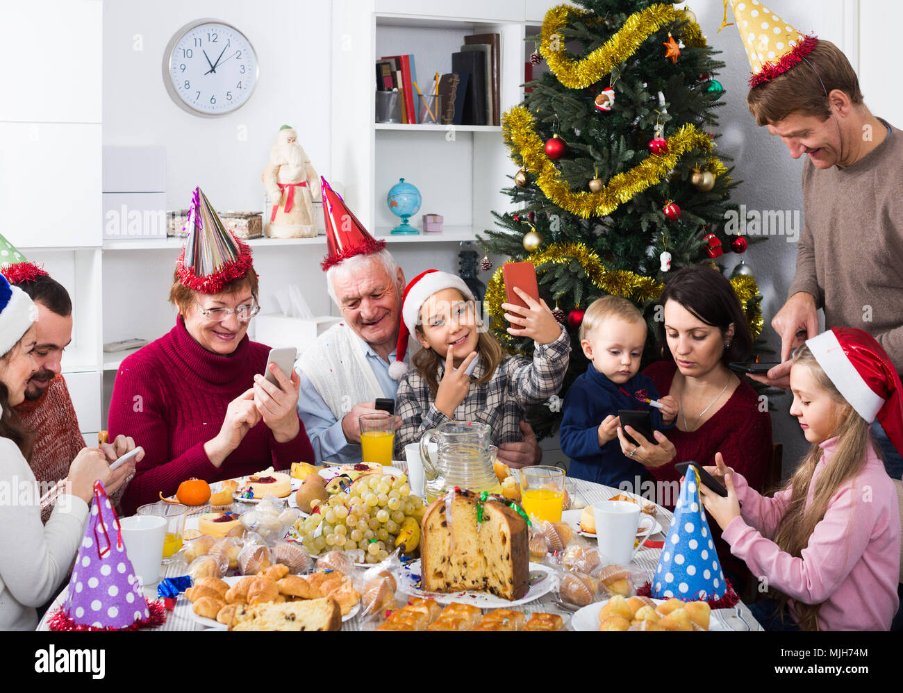 Large happy russian family making numerous photos during Christmas ...