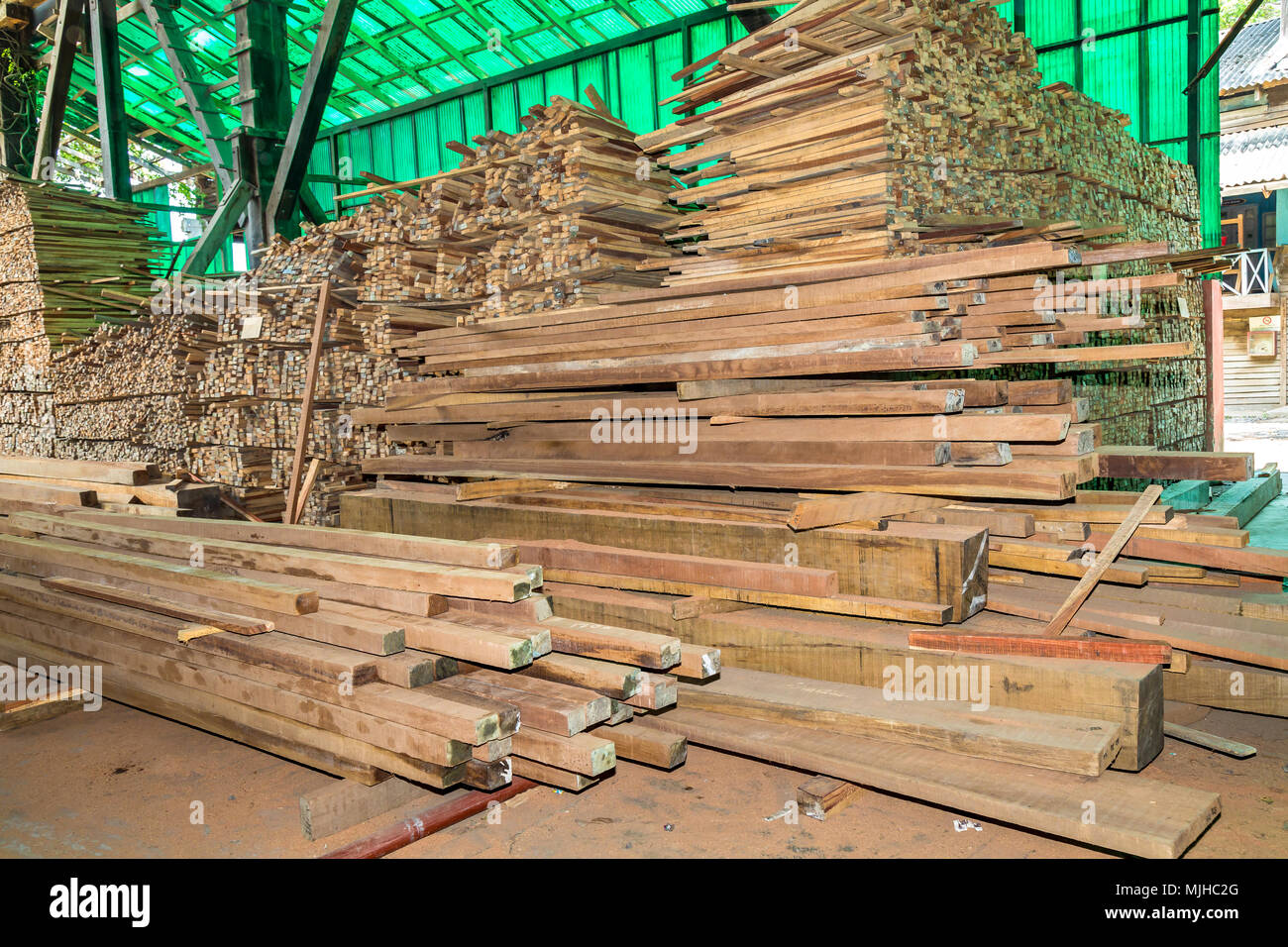 Wooden planks stacked in the warehouse of Chatham sawmill at Port Blair ...