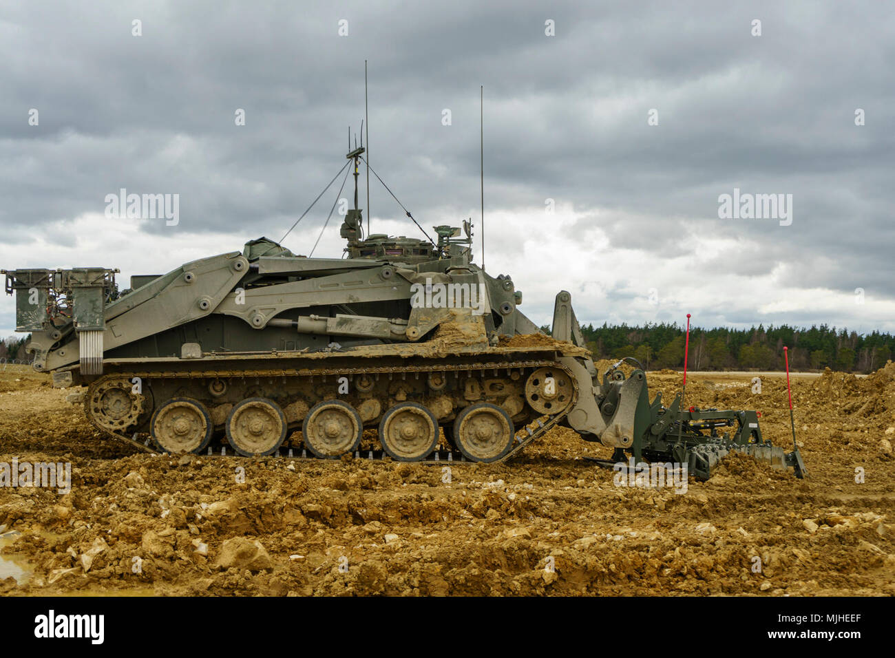 A U.K. Terrier armored digger, operating via remote control, prepares ...
