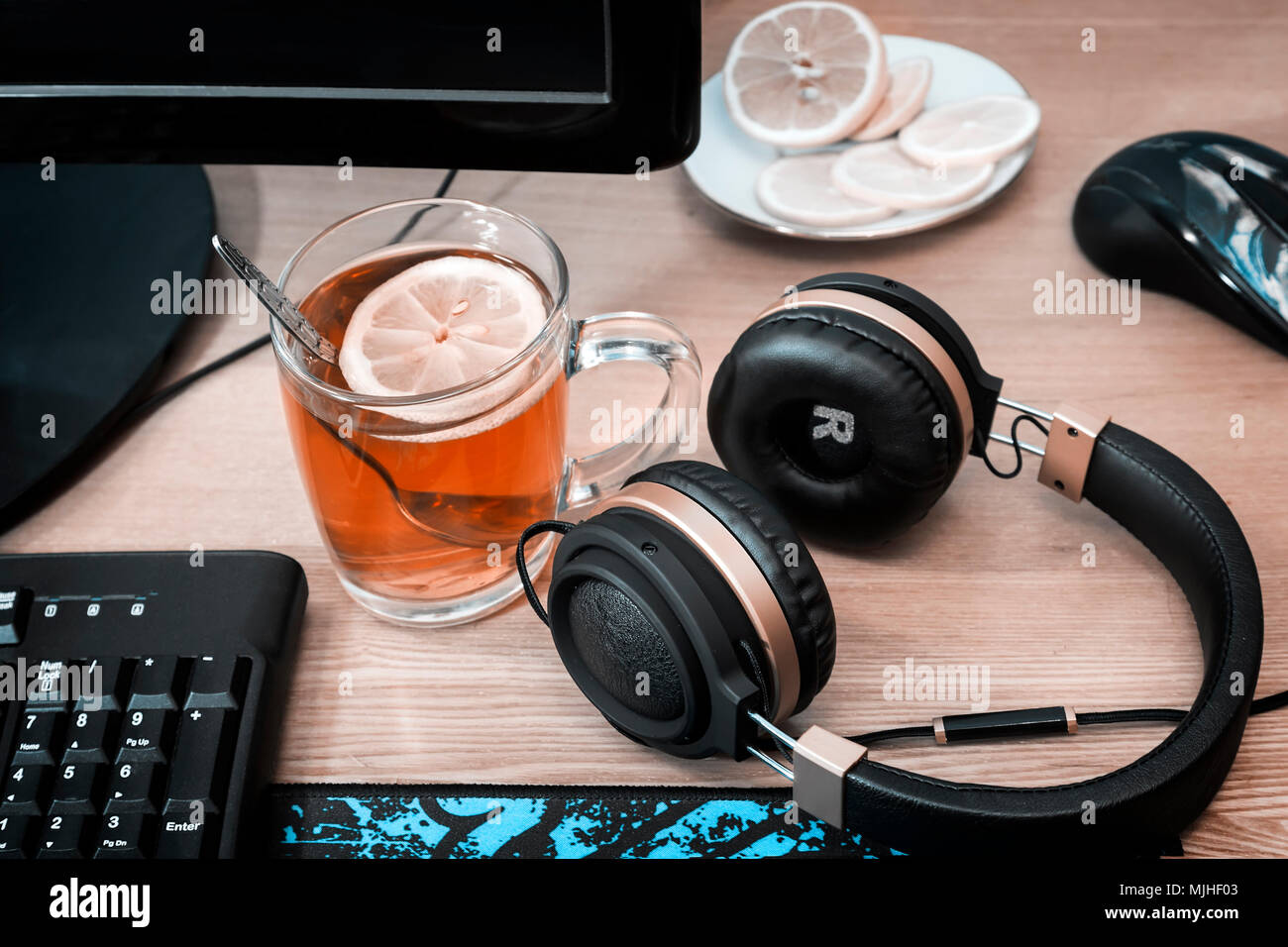 In the workplace at the computer is a Cup of tea with lemon and there ...
