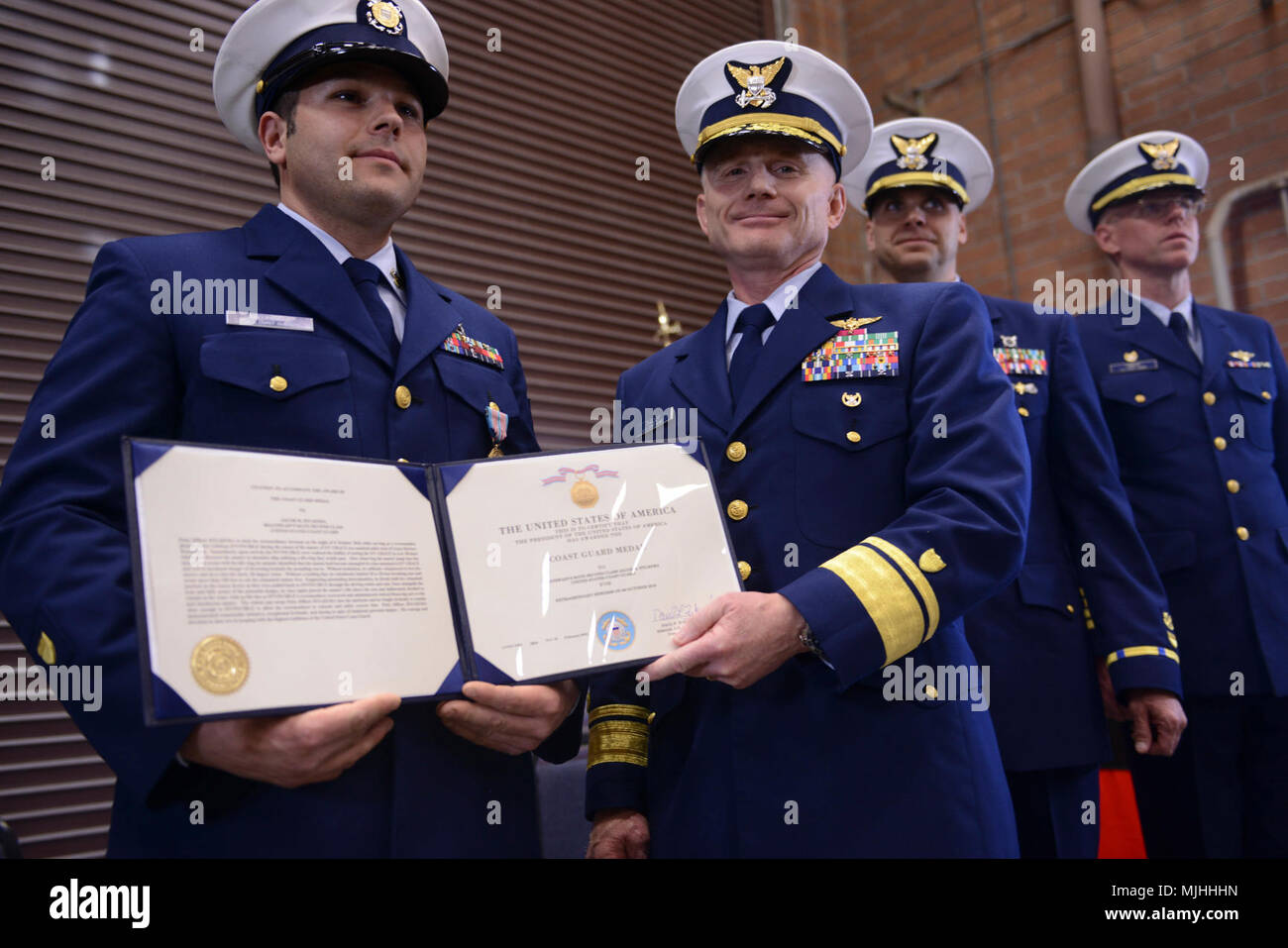 Rear Adm. David Throop, commander Coast Guard 13th District, presents ...