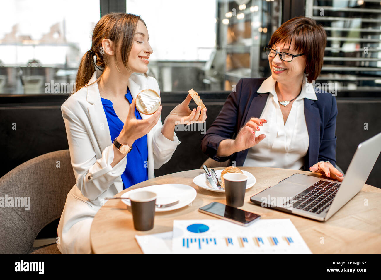 Business women during a coffee time in the cafe Stock Photo - Alamy