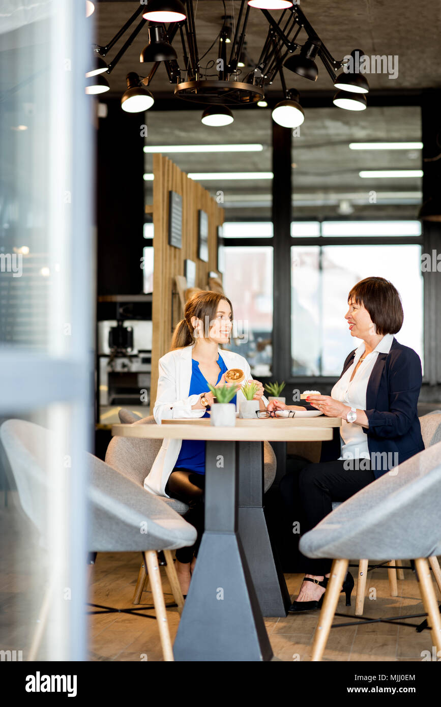 Business women during a coffee time in the cafe Stock Photo - Alamy
