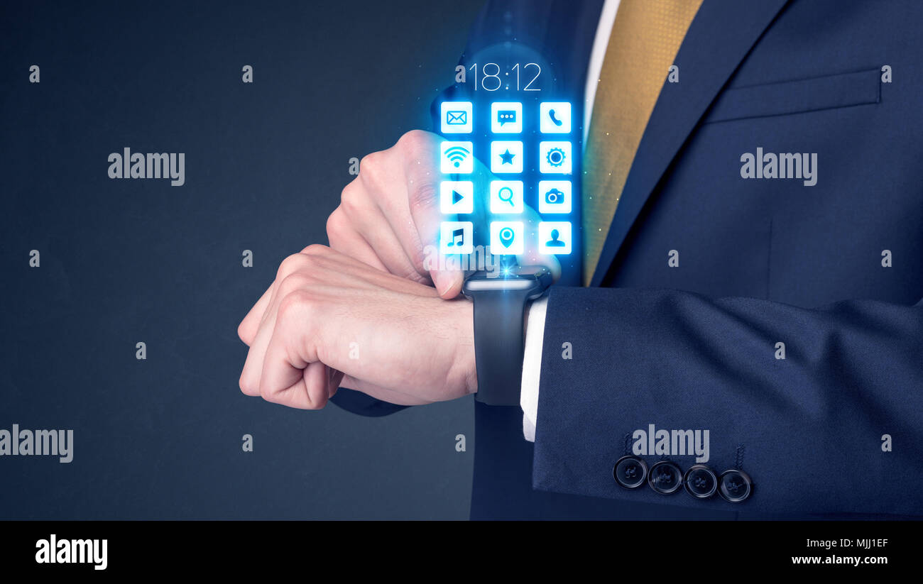 Businessman wearing smartwatch with application icons Stock Photo - Alamy