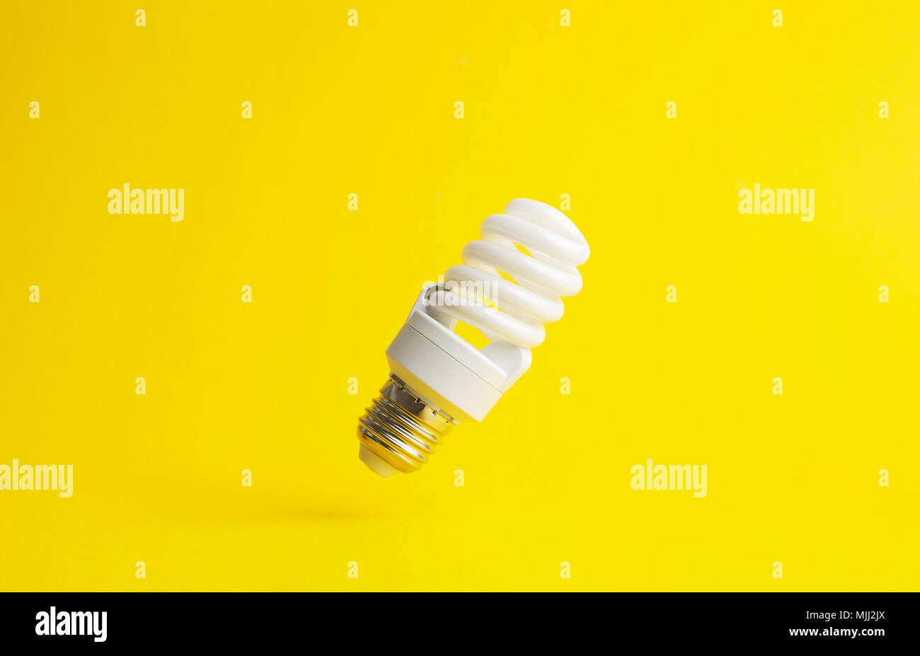 Energy saving light bulb falling on the ground Stock Photo - Alamy