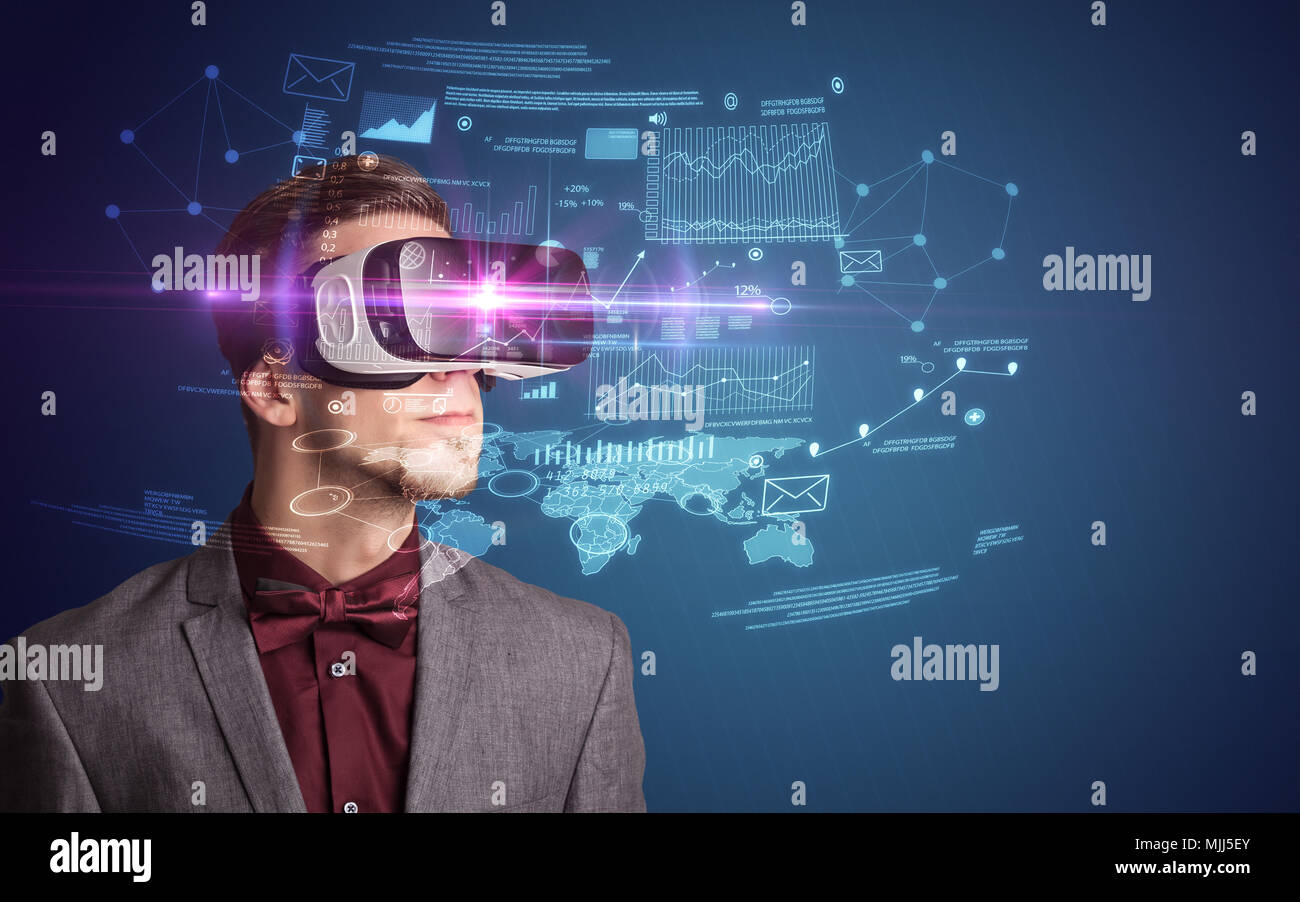 Amazed businessman with virtual reality business plan in front of him ...