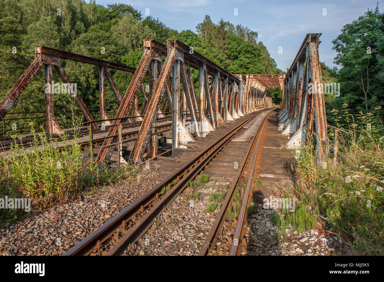 View for the track and rust, metal rail crossing Stock Photo - Alamy