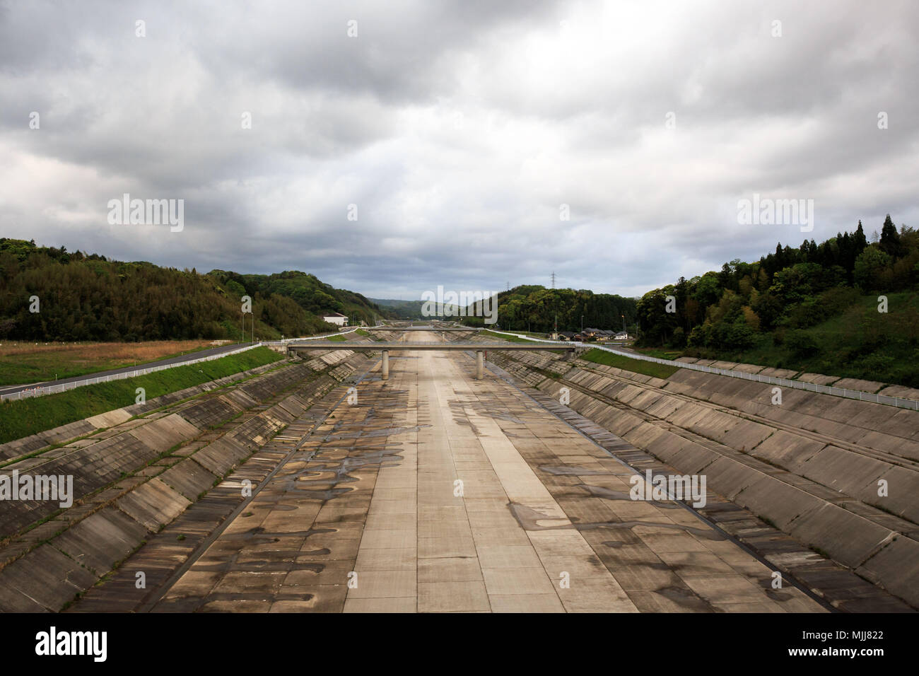 Dry concrete riverbed designed to manage heavy flow Stock Photo - Alamy