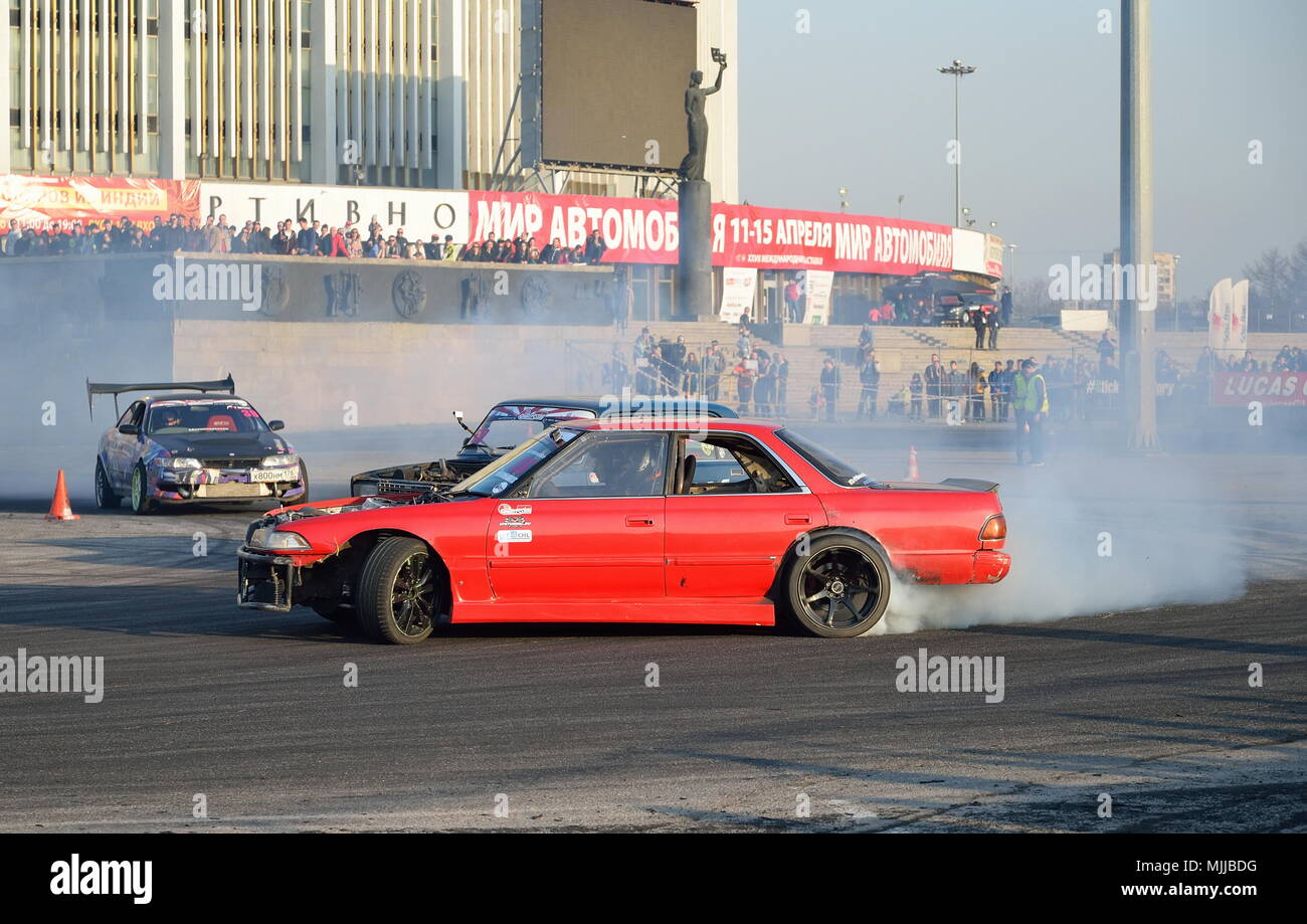 ST.PETERSBURG, RUSSIA - APRIL 15, 2017: Sports cars drift with smoke on ...