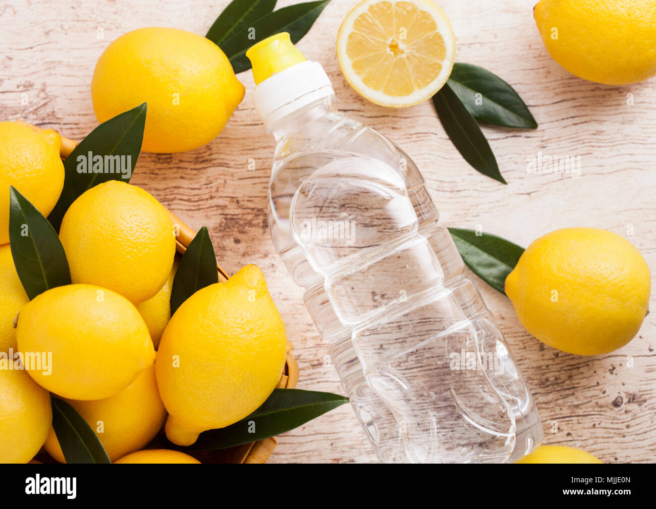Plastic bottle of organic fresh lemon still summer water with raw ...