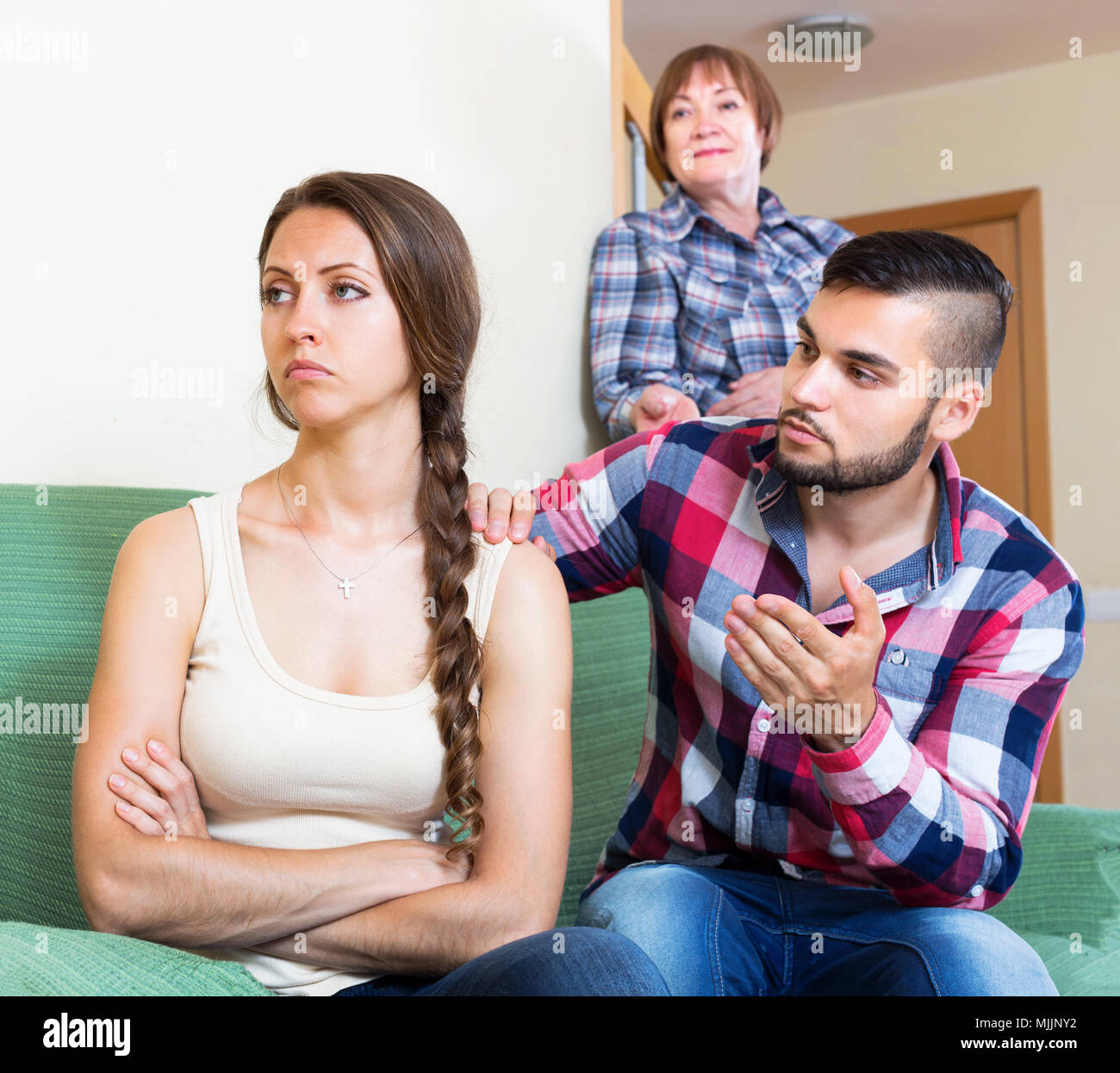 Sad family discussion about problem at home interior Stock Photo - Alamy