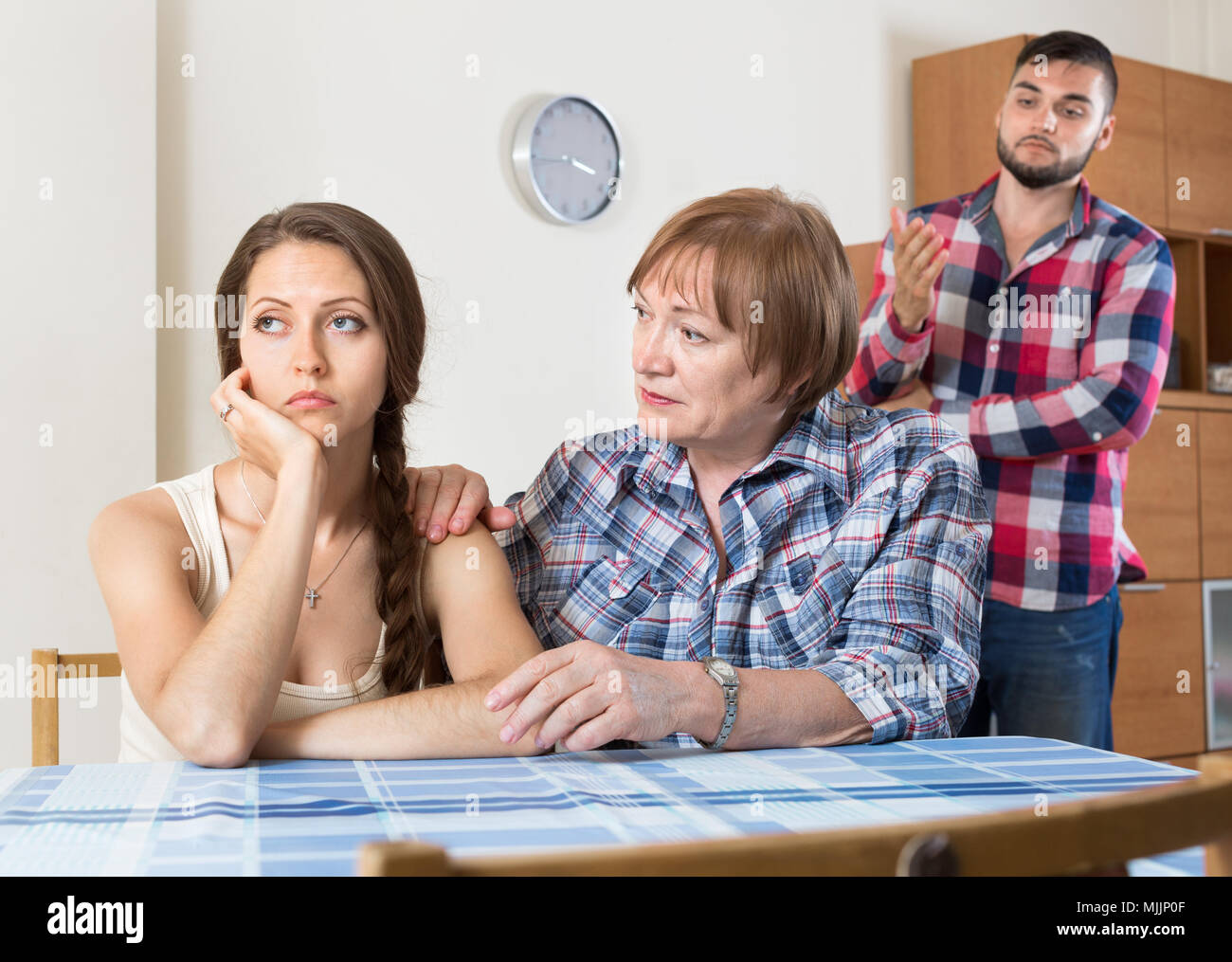 Mother comforting young daughter after a family conflict Stock Photo ...