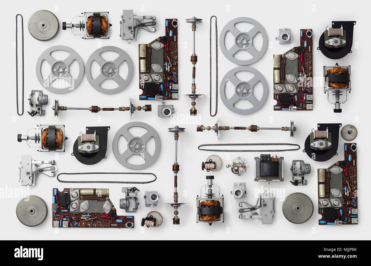 Parts of a vintage film projector well arranged over white background ...