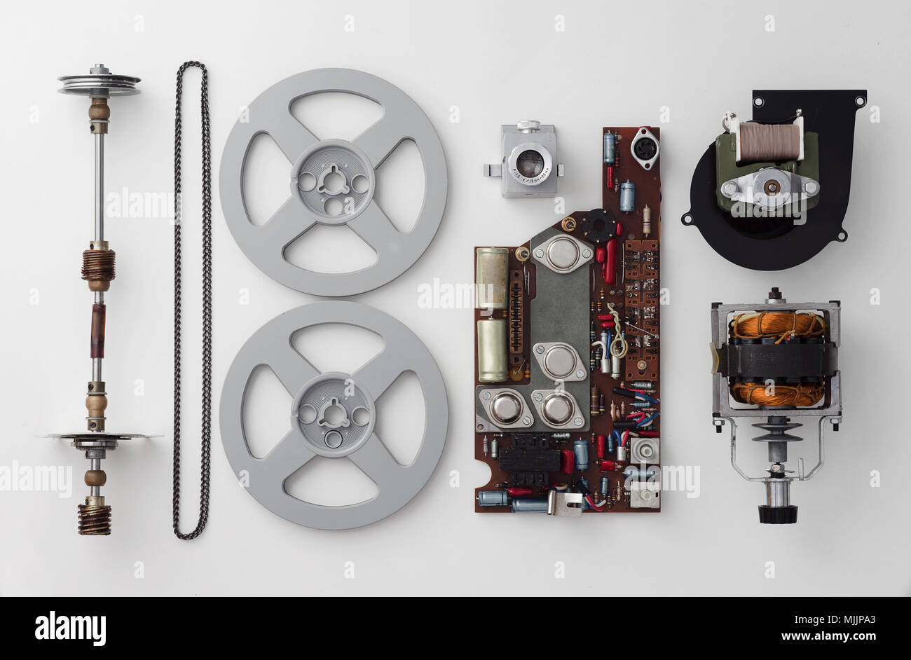 Parts of a vintage film projector well arranged over white background ...