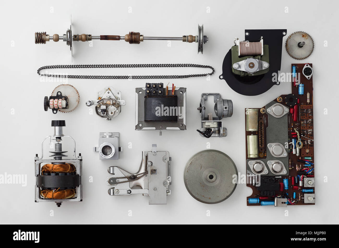 Parts of a vintage film projector well arranged over white background ...