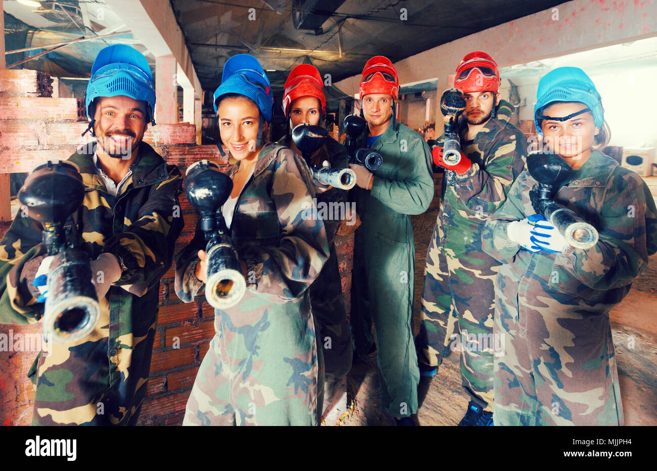 Portrait of friends who are ready for paintball playing Stock Photo - Alamy